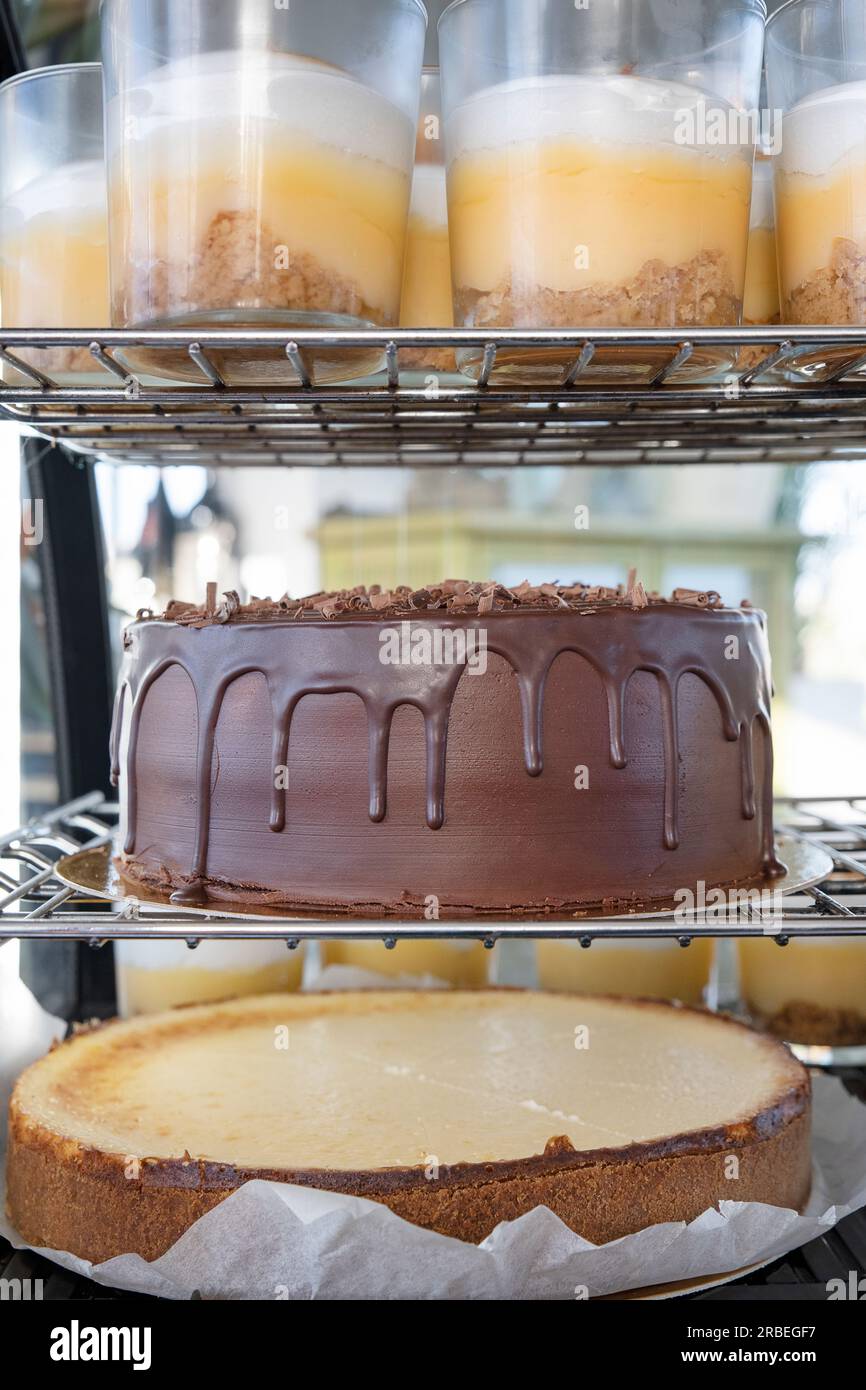 Dessert display fridge filled with some decadent sweet treats such as ...