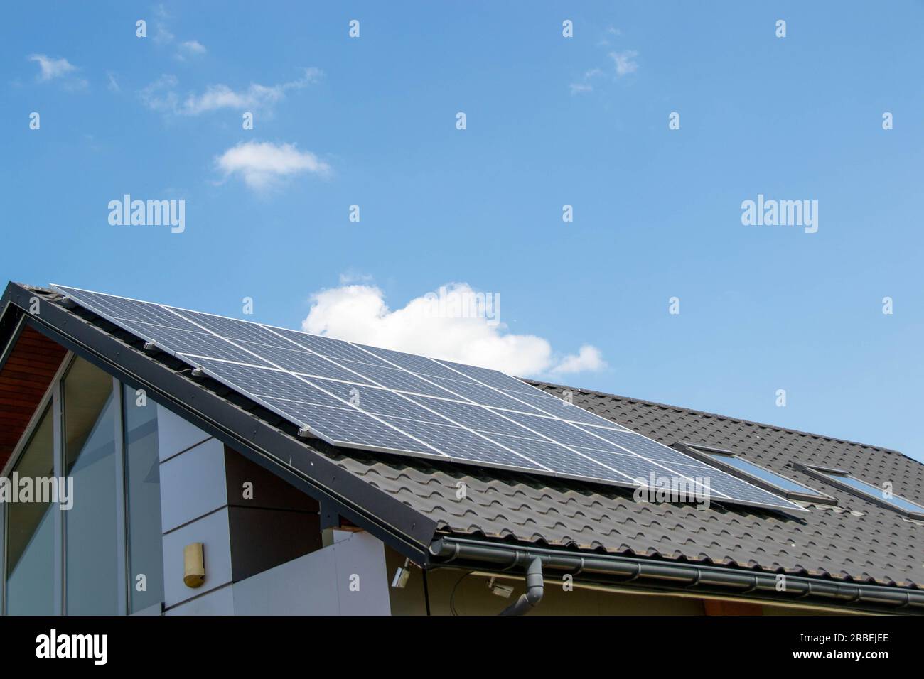 House roof with photovoltaic modules. Historic farm house with modern ...
