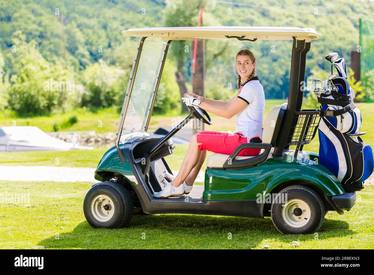 Woman sitting in golf cart hi-res stock photography and images - Alamy