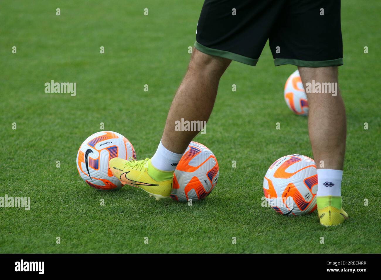 A football player's foot kick a soccer ball in the Pari Premier Cup ...
