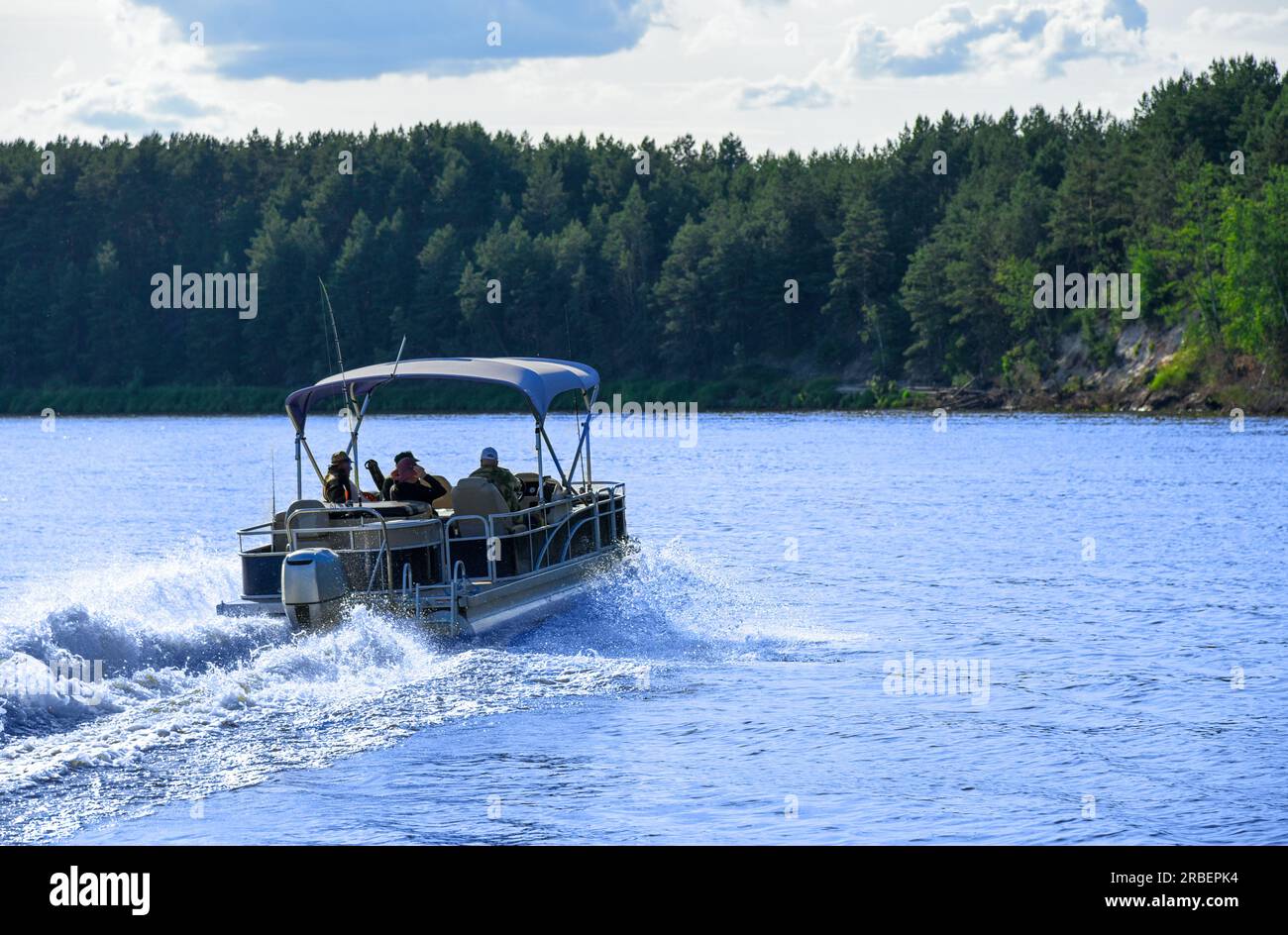 A group of people ride a boat on the river Stock Photo - Alamy