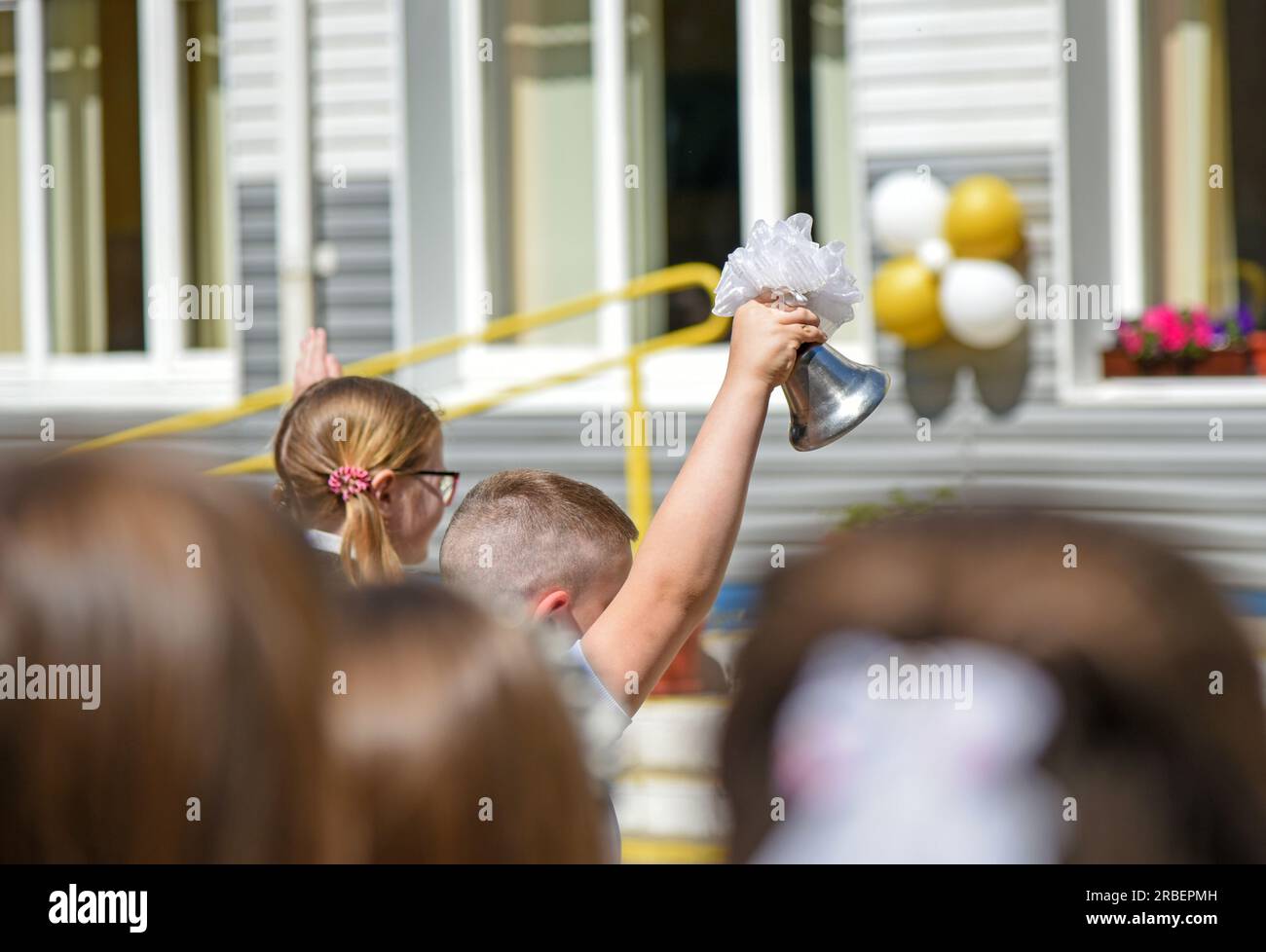 Children at school carry a bell at the first bell Stock Photo - Alamy