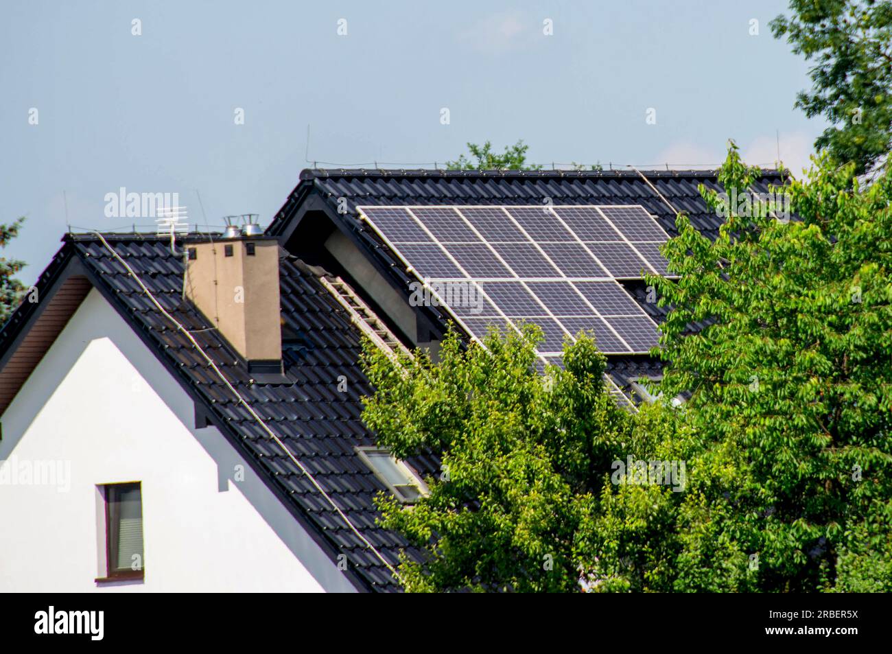 House roof with photovoltaic modules. Historic farm house with modern ...