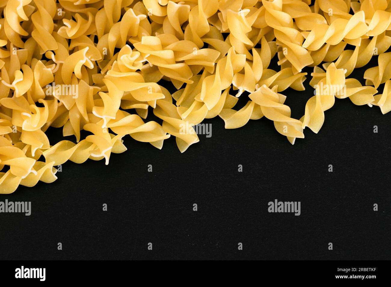 Uncooked Fusilli Pasta with Copy Space on Black Background. Raw and Dry ...
