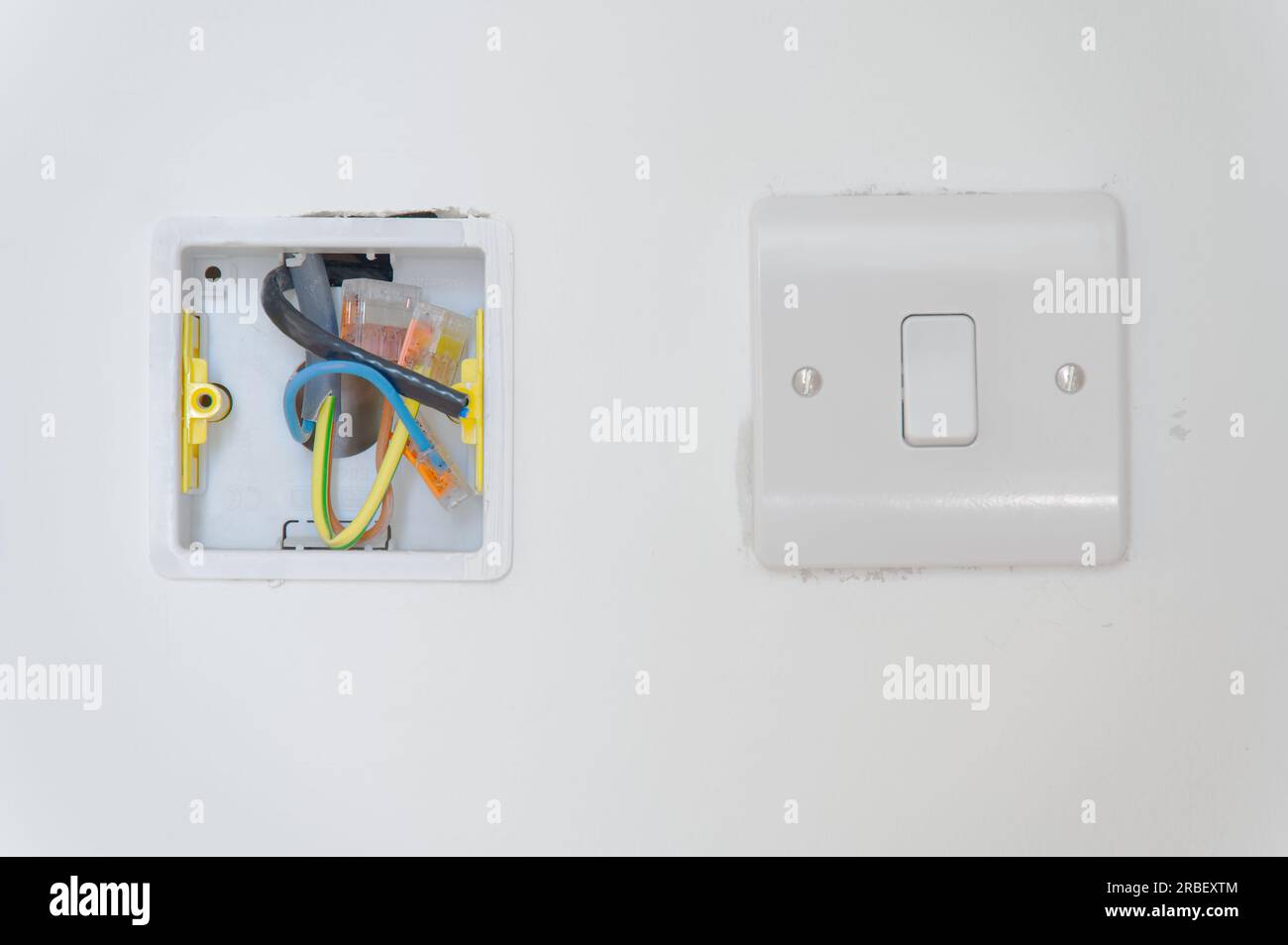 Electrical socket installation and fitted switch on wall Stock Photo ...