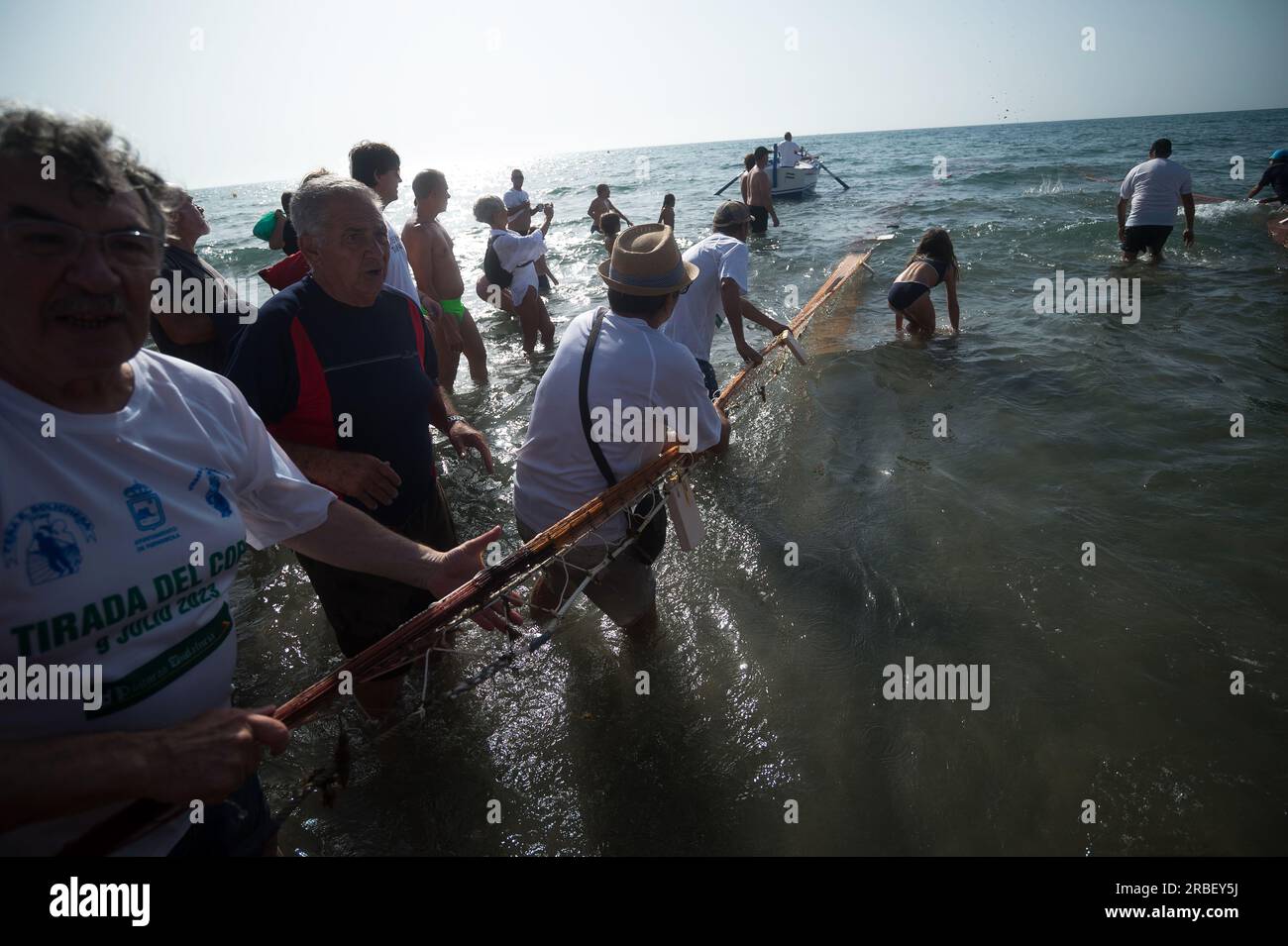 Locals are seen using large nets to capture fish as they take part in ...
