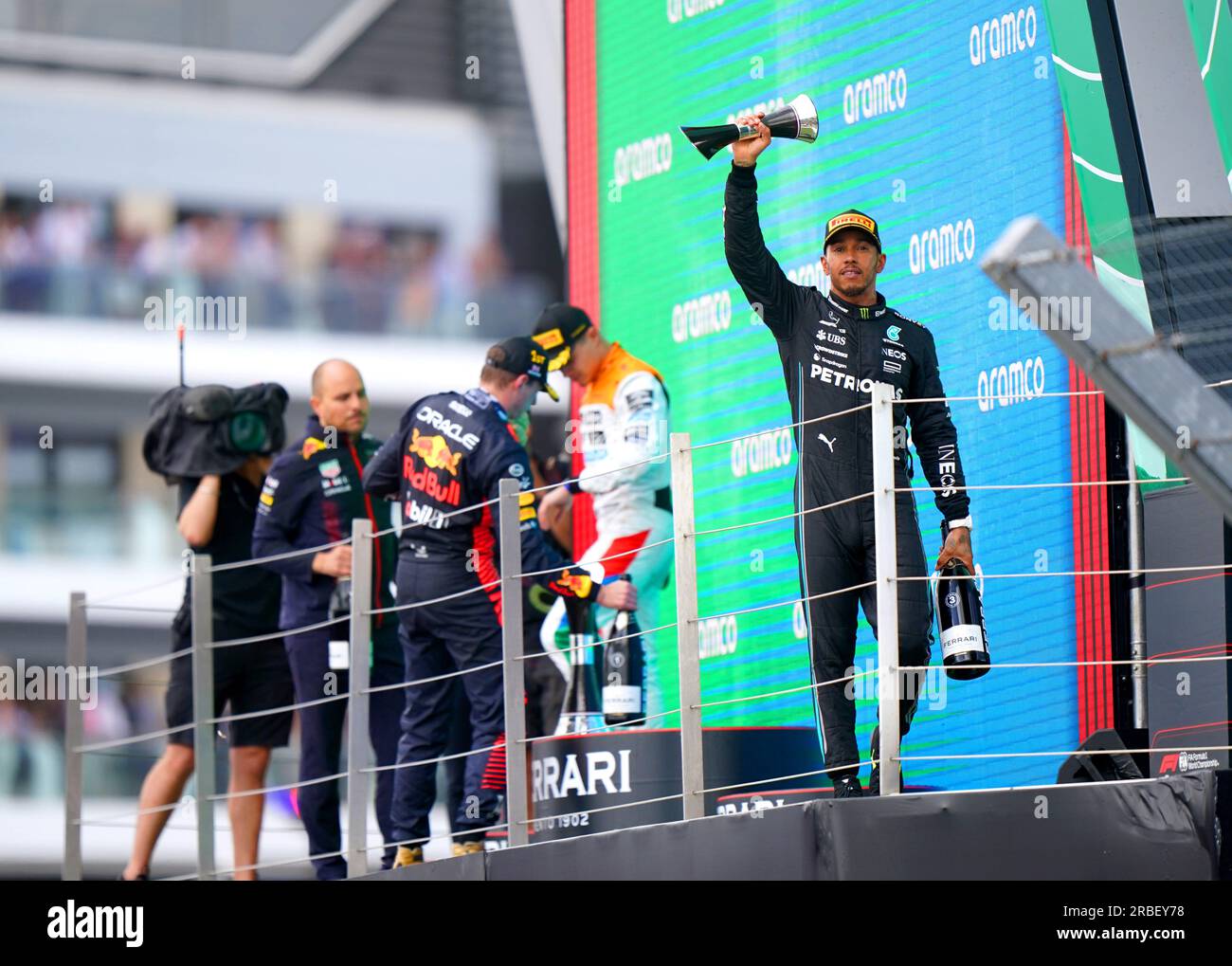 Mercedes' Lewis Hamilton holds his trophy in the air as he celebrates ...