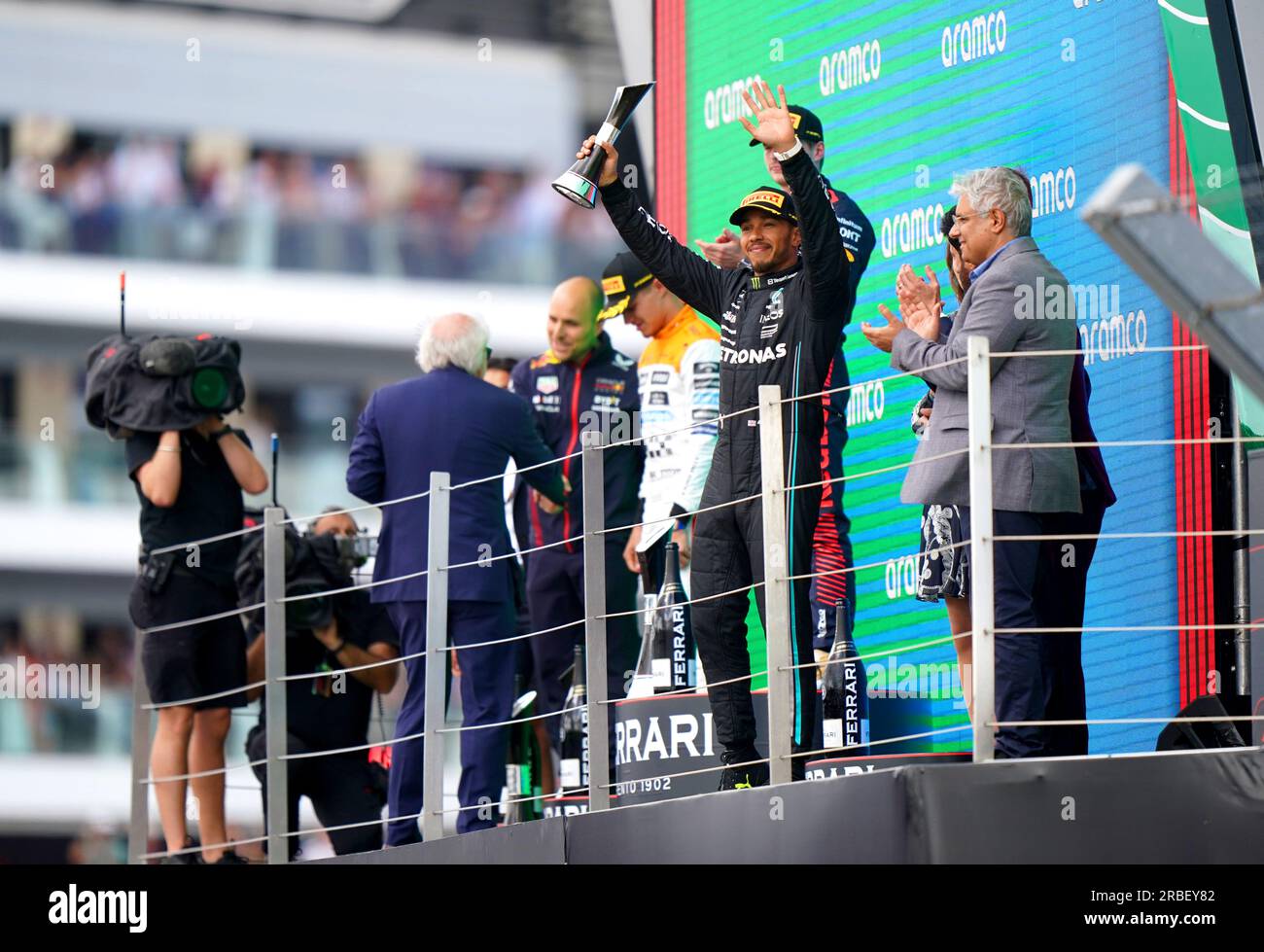 Mercedes' Lewis Hamilton gestures to the fans from the podium after ...