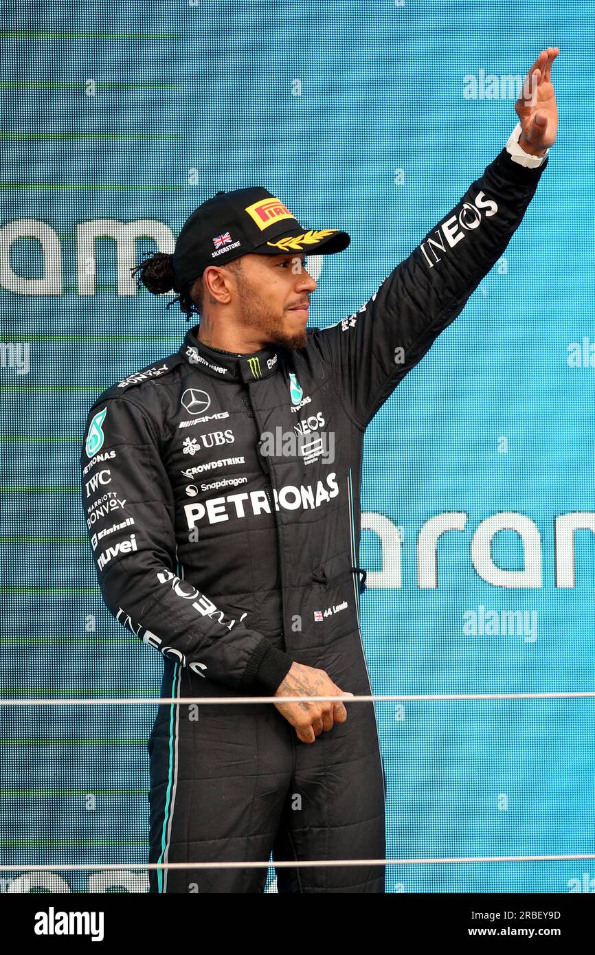 Mercedes' Lewis Hamilton waves to fans from the podium following the ...