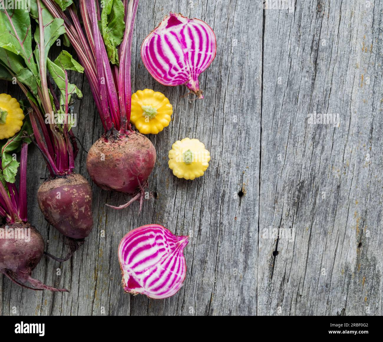 Fresh raw organic beets with patty pan squash on a rustic board Stock ...