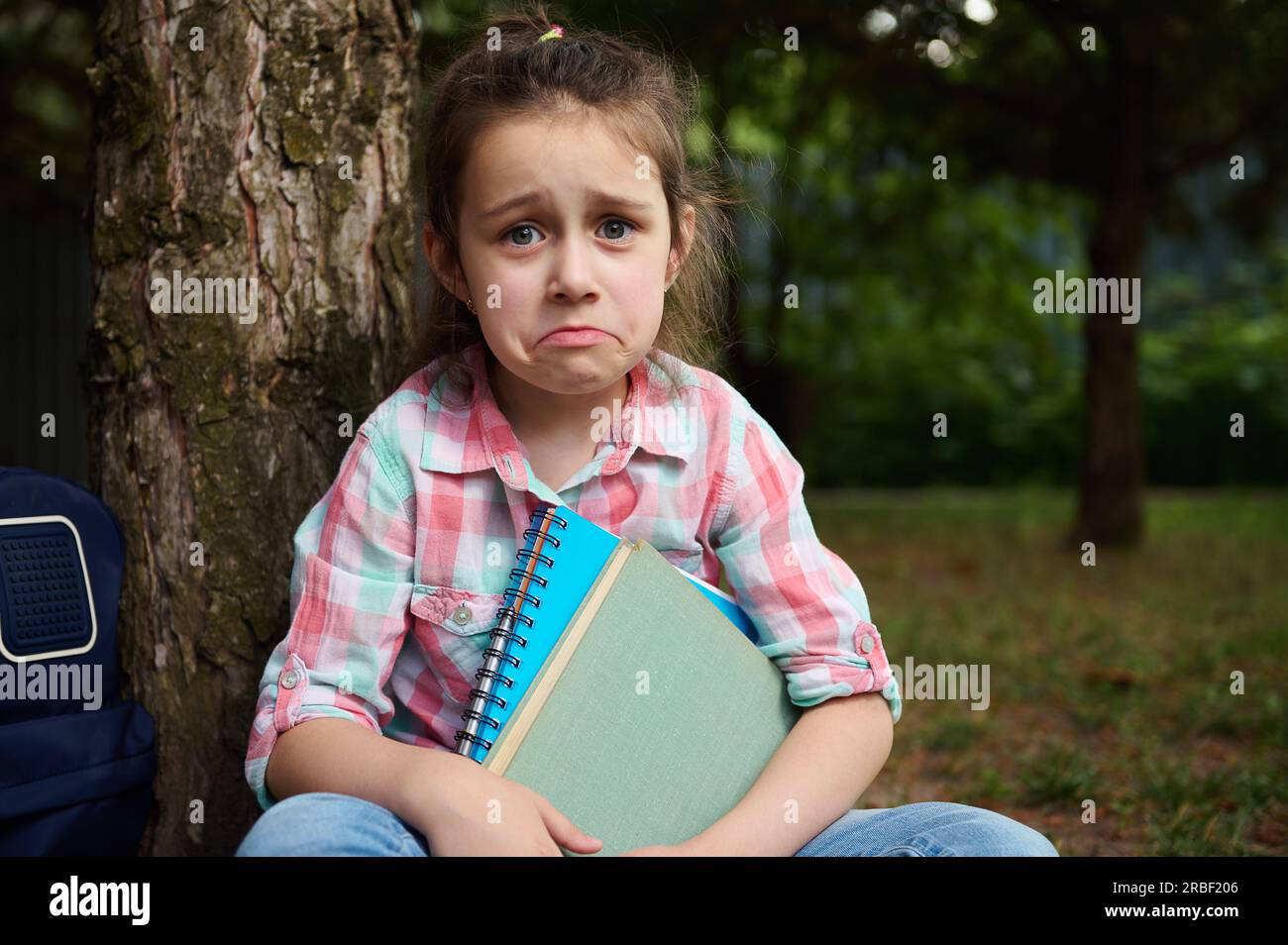 Caucasian sorrowful little kid girl 6 years old, primary school student ...