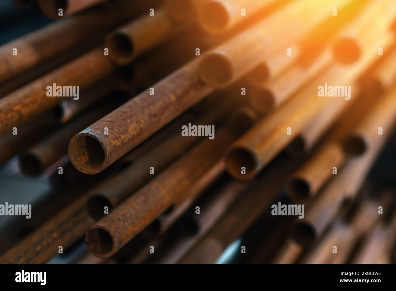 Round metal pipes of small diameter lie in stack. Front view. Pipes for ...