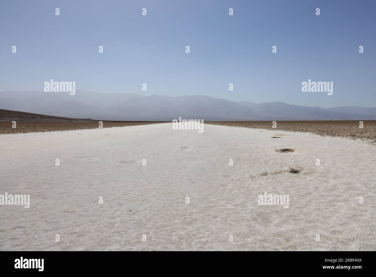 The salt flats at Badwater Basin stretching out to the horizon with ...