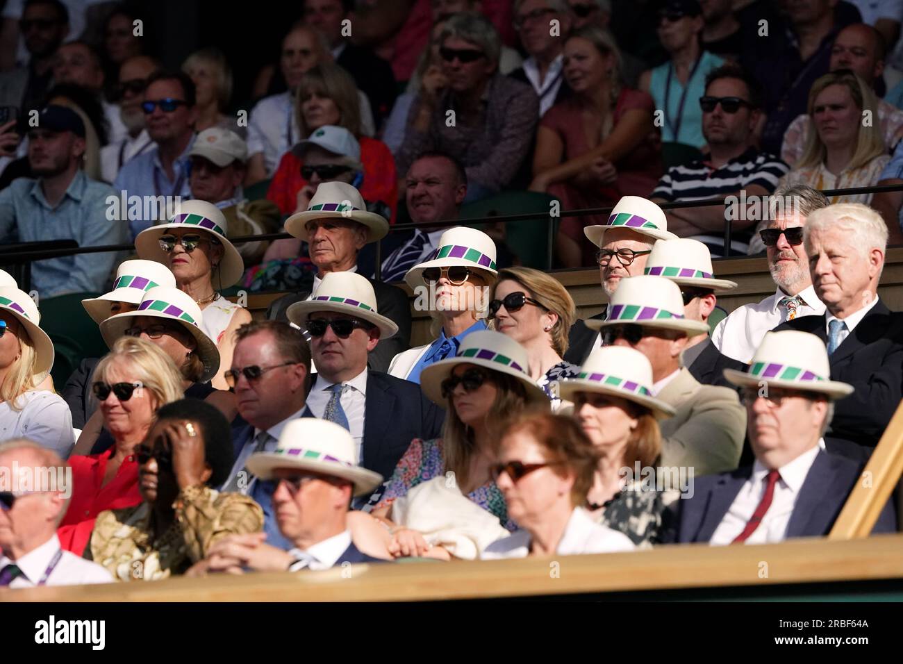 Spectators in the royal box wearing Wimbledon sun hats on day seven of ...