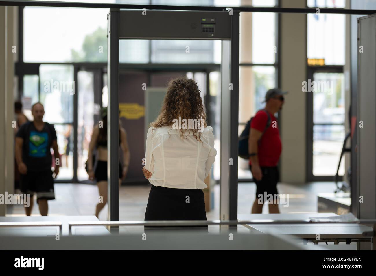 Security personnel checking bags and backpacks x-rayed at the access ...