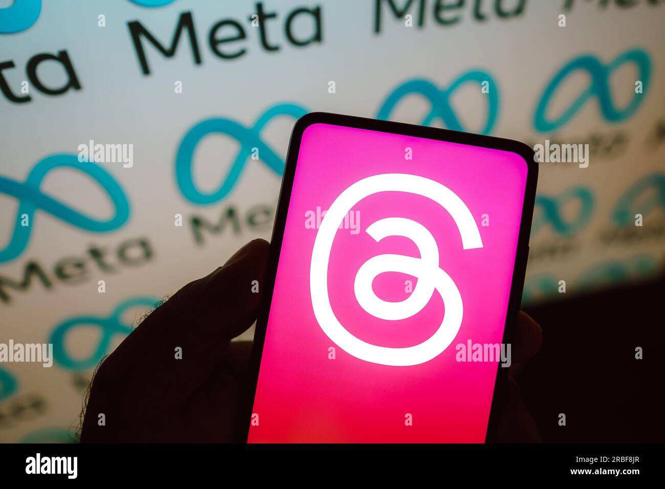 In this photo illustration, the Threads logo is displayed on a ...