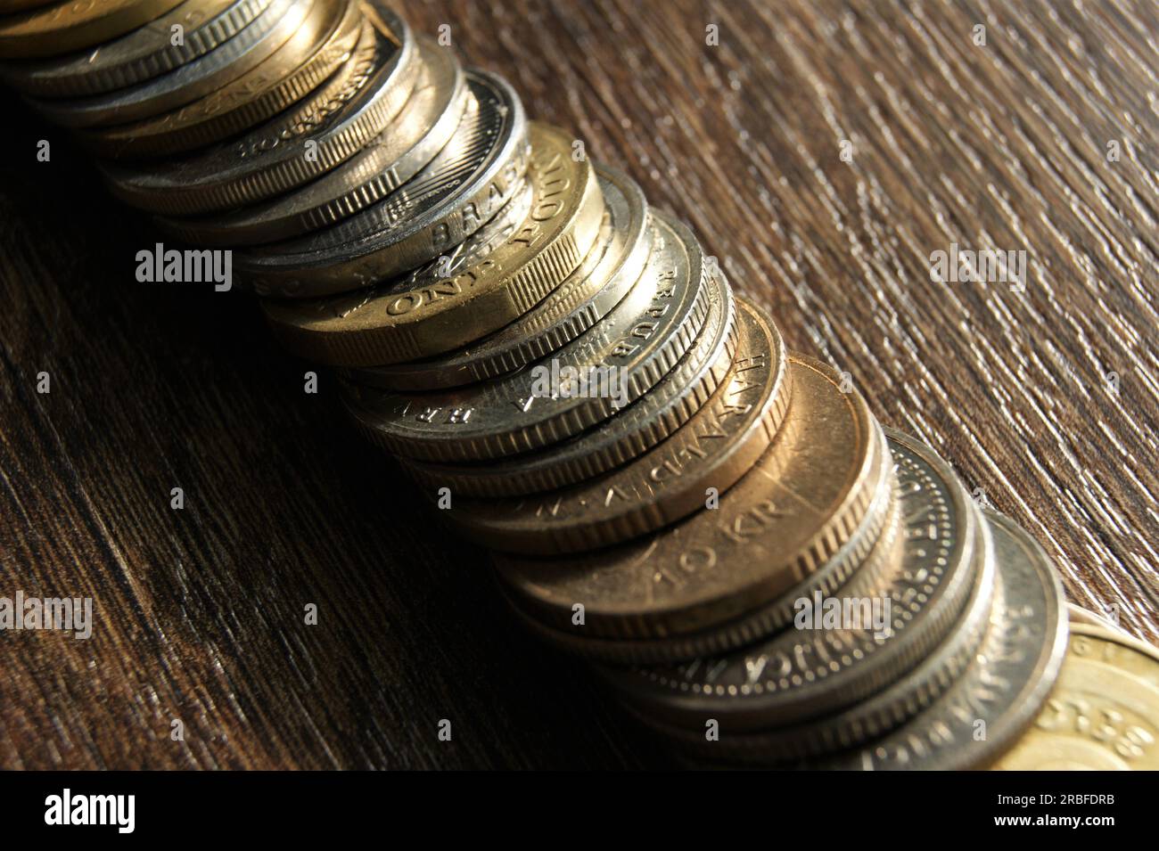 Edges of different coins. Pile of coins of different countries on a ...