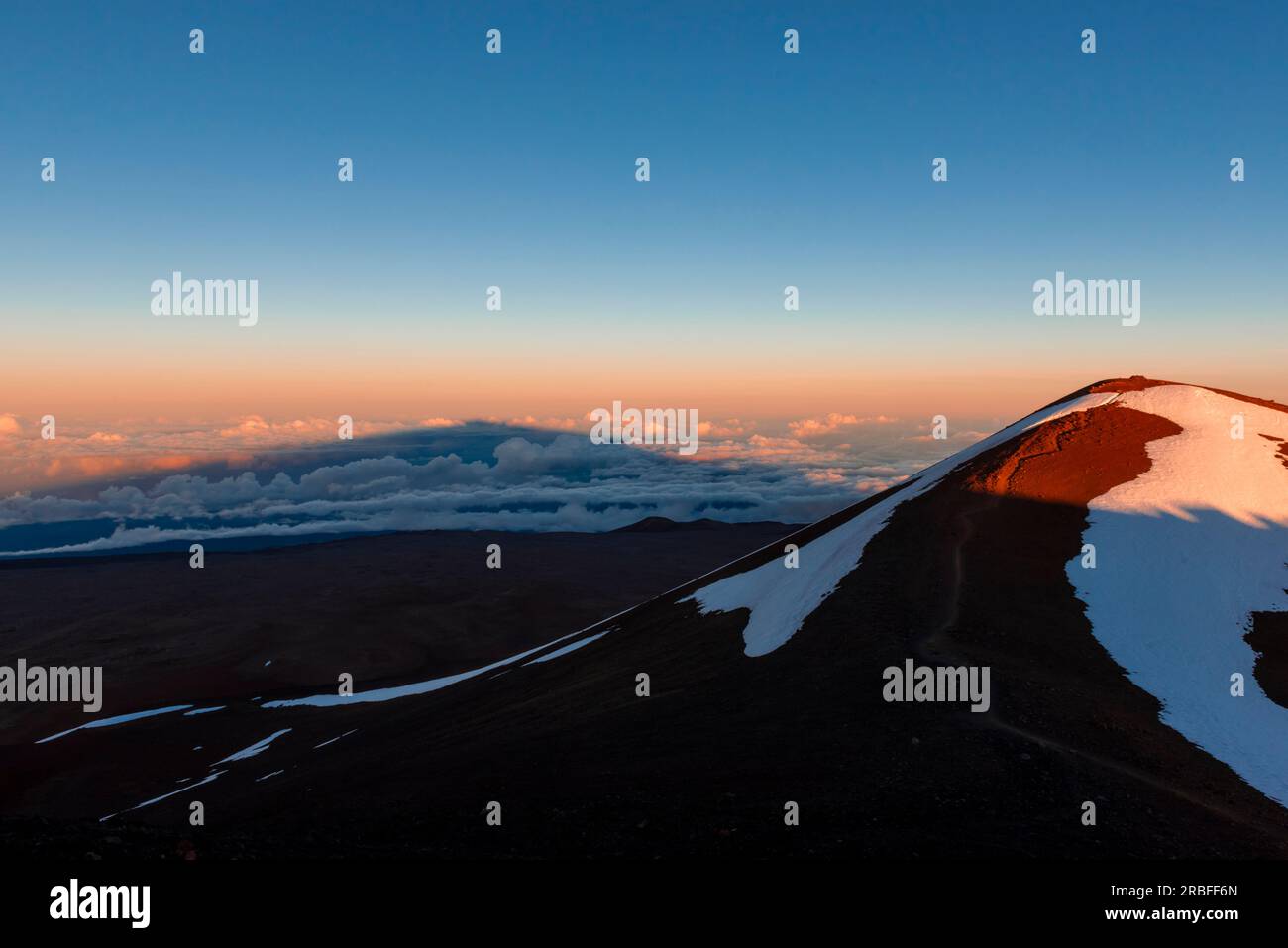 Shadow of Mauna Kea volcano cast at sunset Stock Photo - Alamy