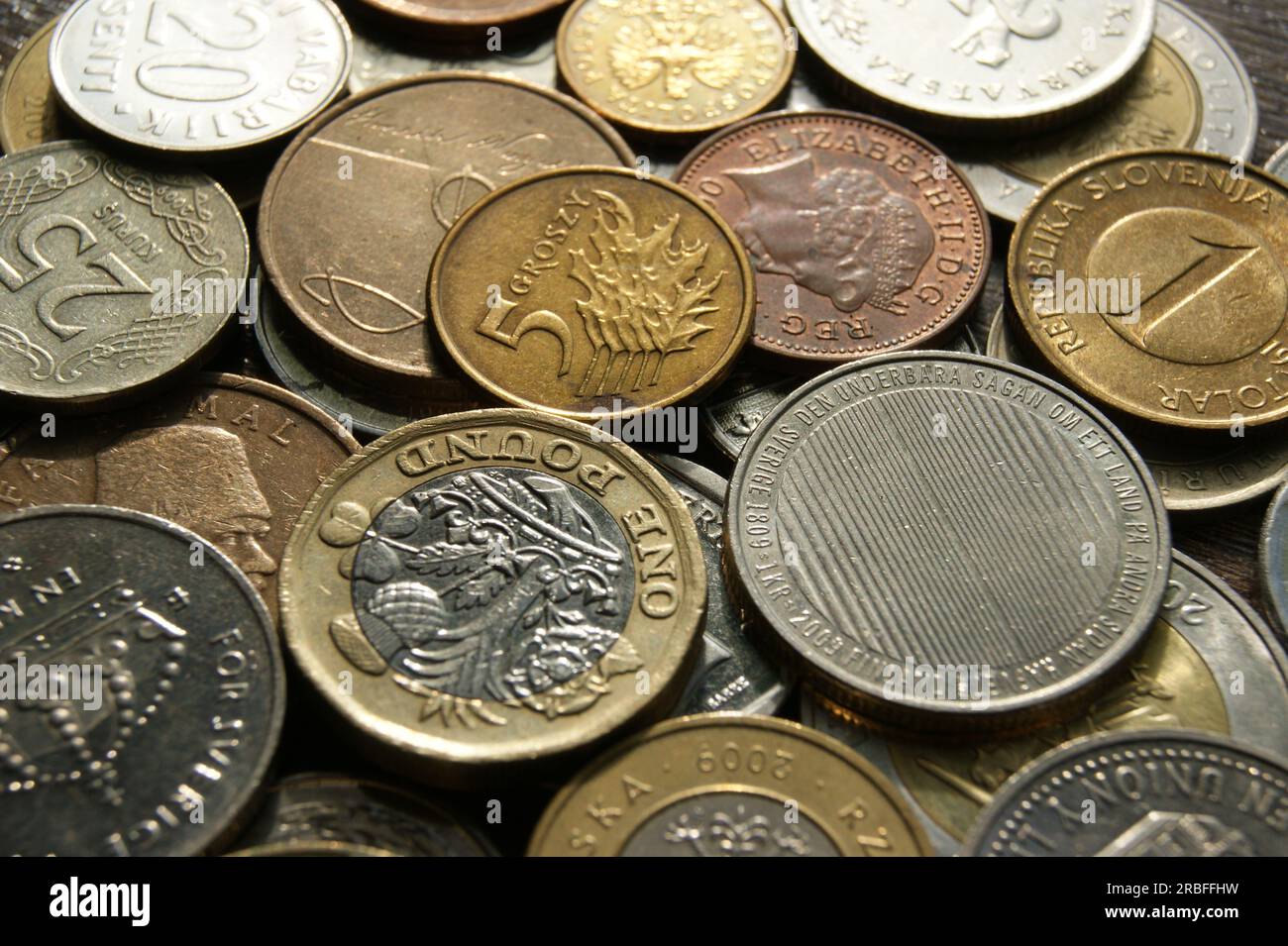 Close-up of coins of different countries. Pile of coins background ...