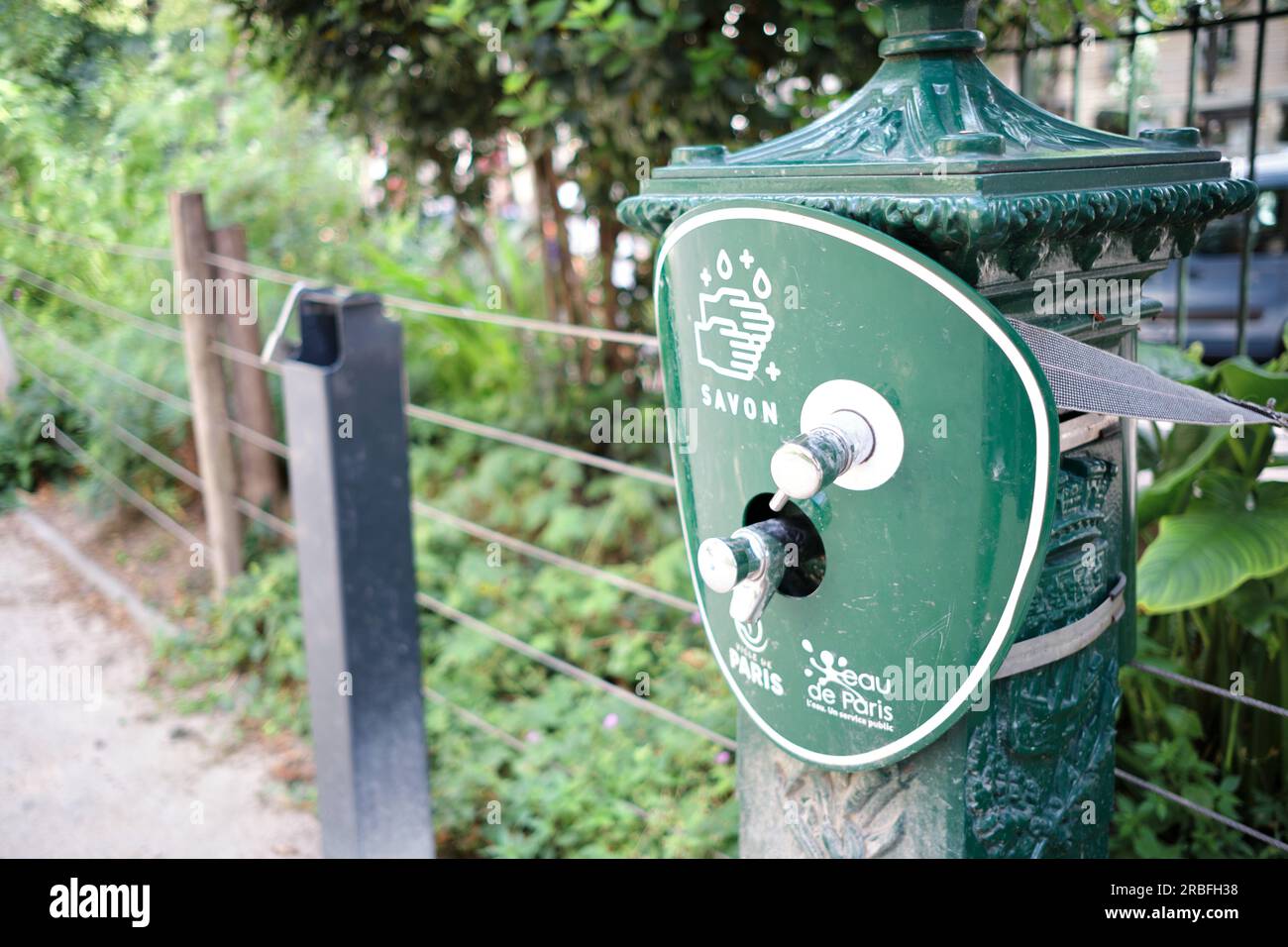 Paris, France - 07.01.2023: Green outdoor hand washing faucet from Eau ...