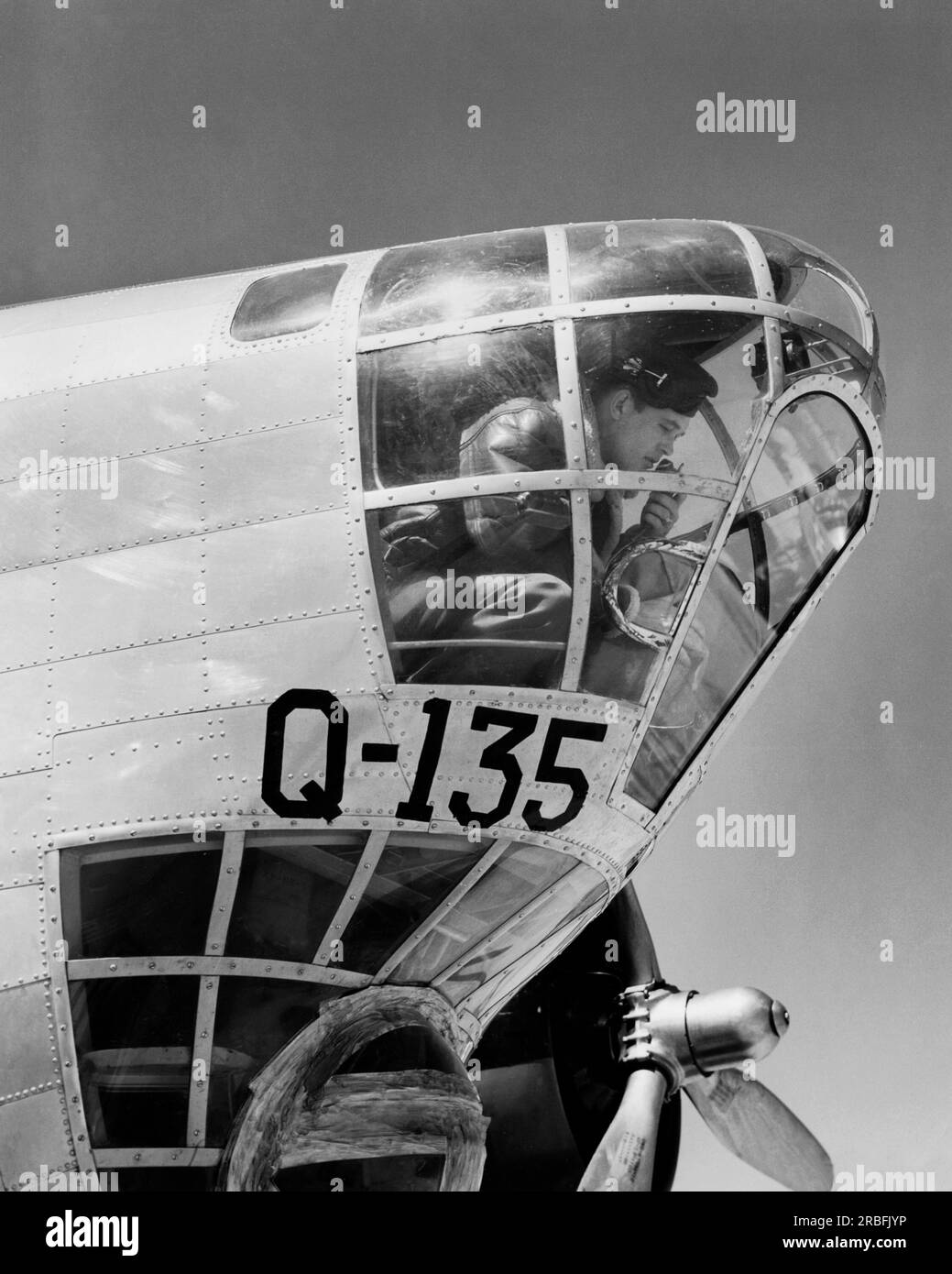 United States: c. 1941 An WWII Army Air Force bombardier in the nose of ...