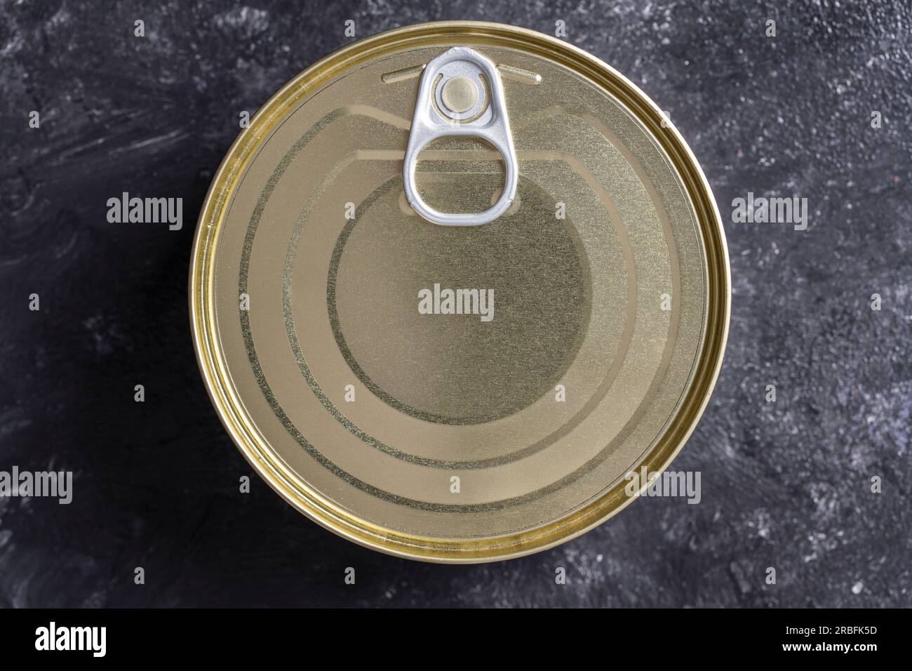 Closed canned food on a black background, close up, top view Stock ...