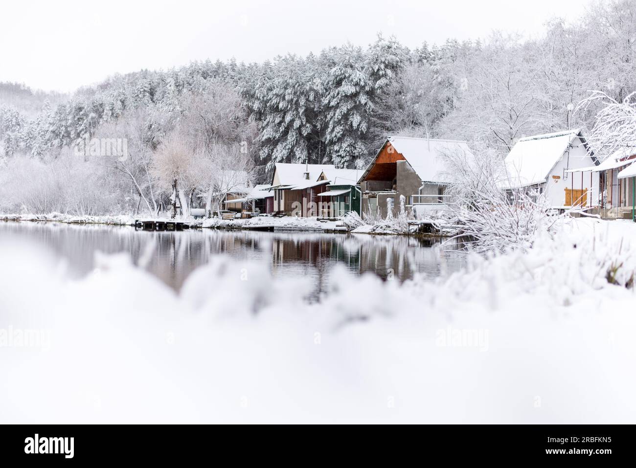 lakeside cottages in snowy winter landscape Stock Photo - Alamy
