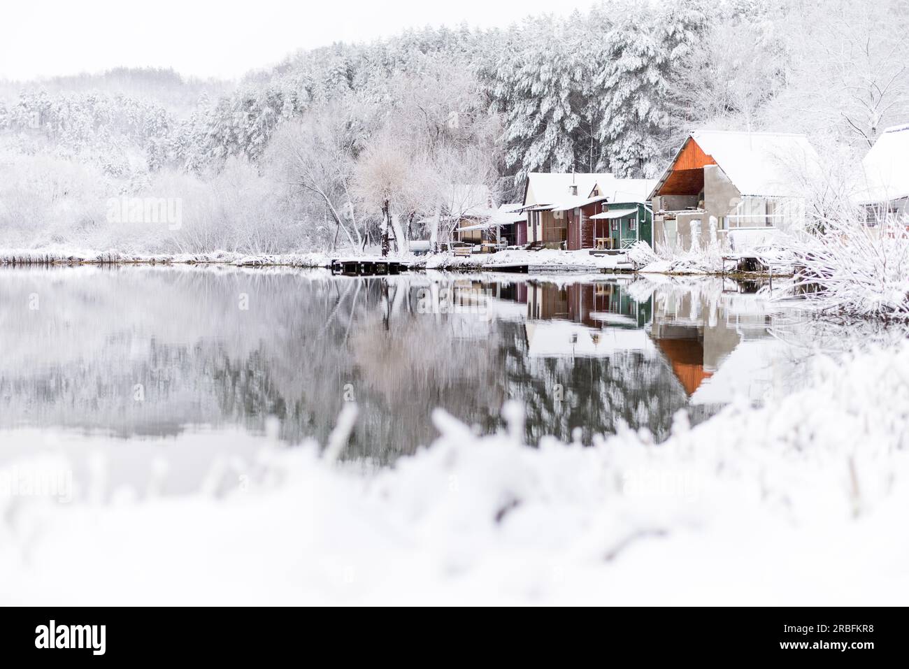lakeside cottages in snowy winter landscape Stock Photo - Alamy