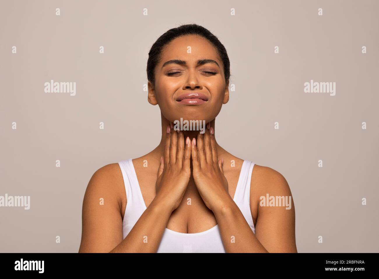 African american woman in pain touching her neck, checking adenoids ...