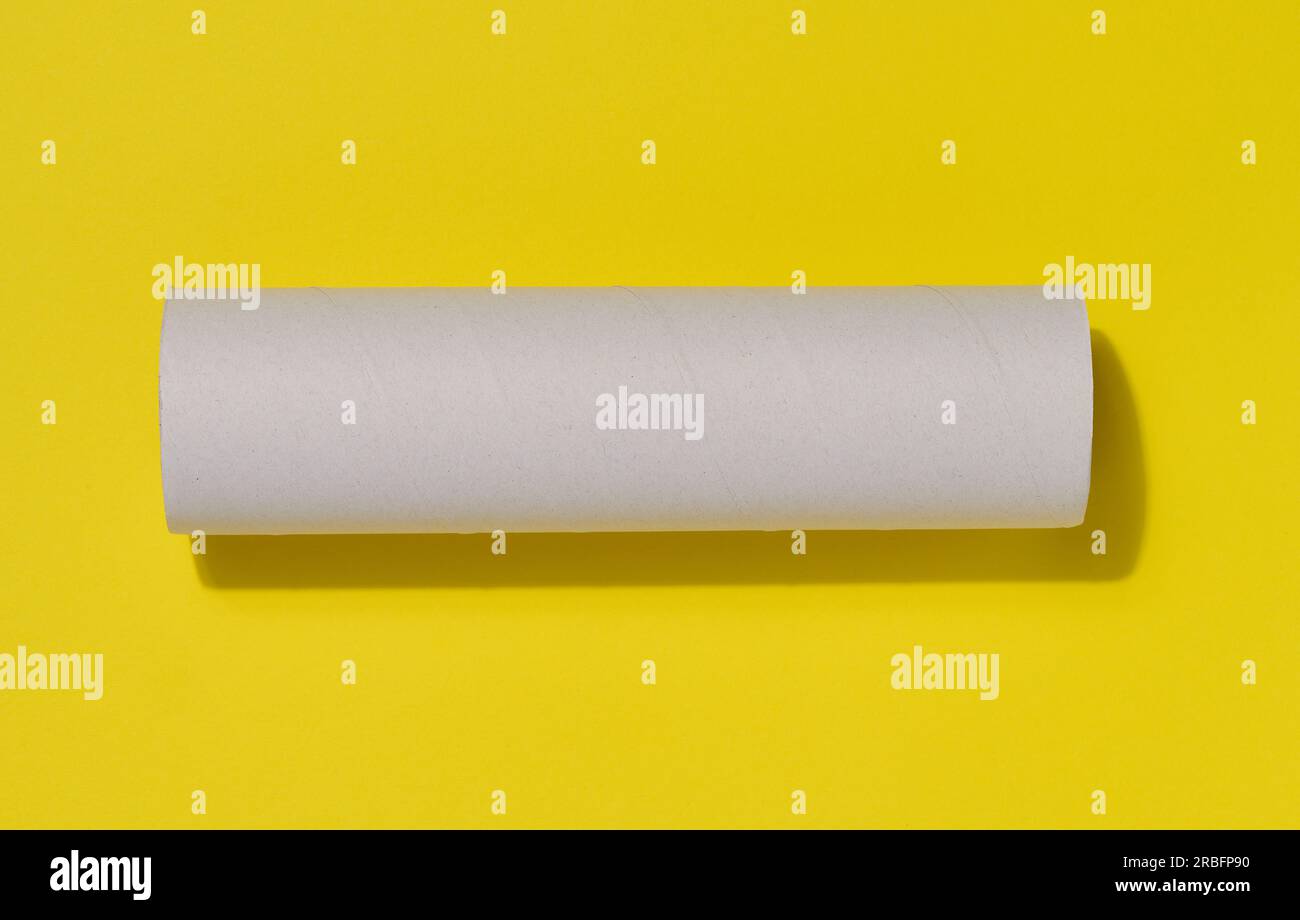 White paper towel from a roll of kitchen towels, object on a yellow ...