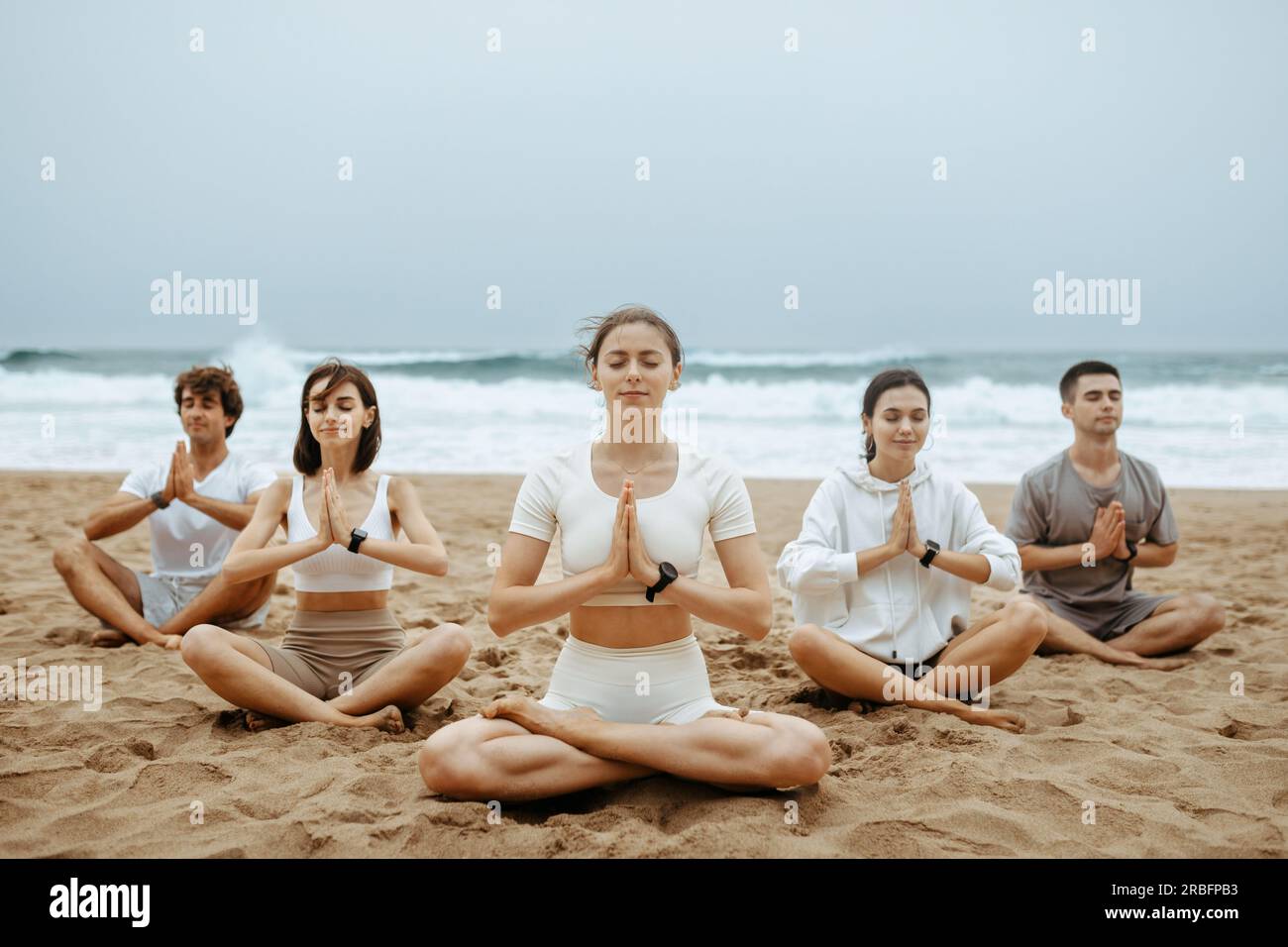 Group praying on beach hi-res stock photography and images - Alamy