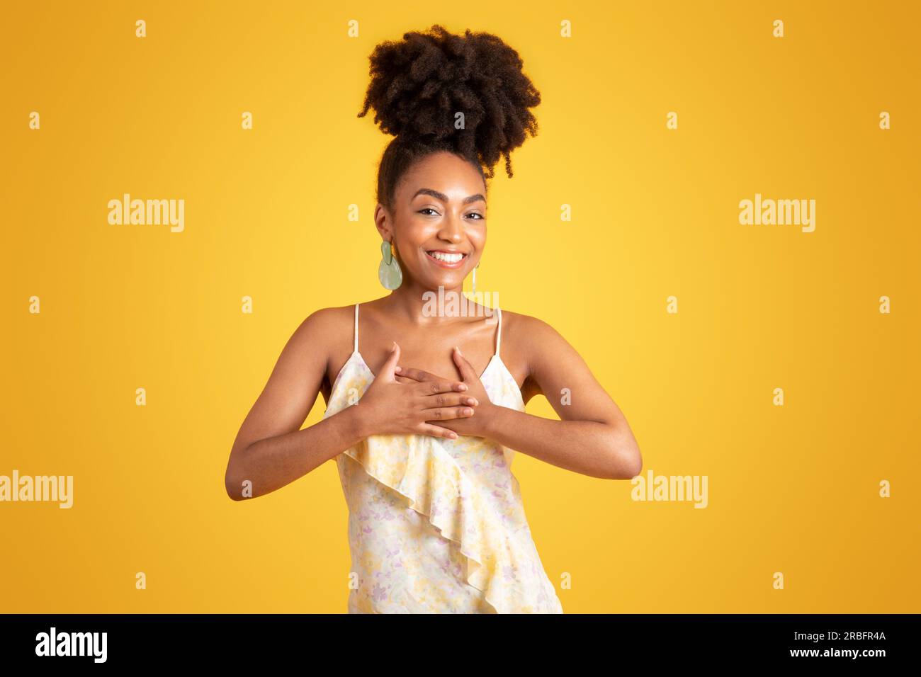 Cheerful millennial african american lady presses hands to chest, say ...