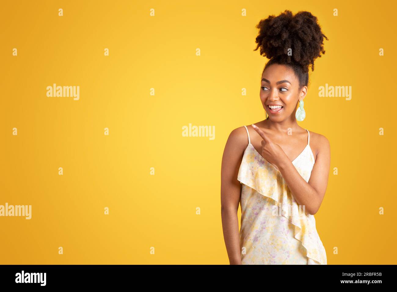 Smiling pretty millennial african american lady pointing finger at ...