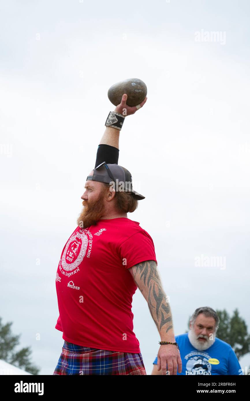 An athlete stretches before throwing in the stone put competition at ...