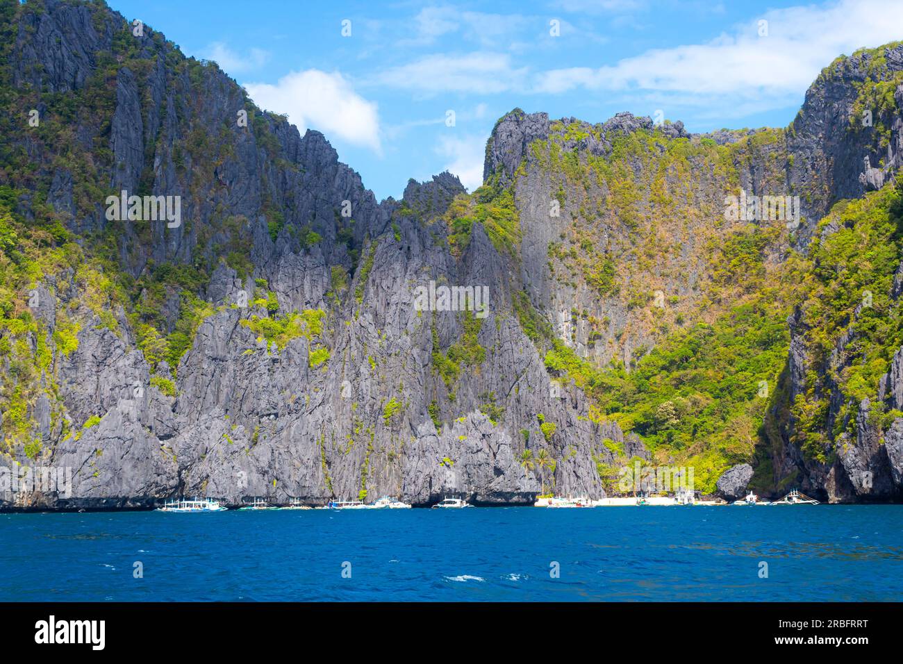 Beautiful coral reef, boats and a clear ocean on Matinloc Island ...