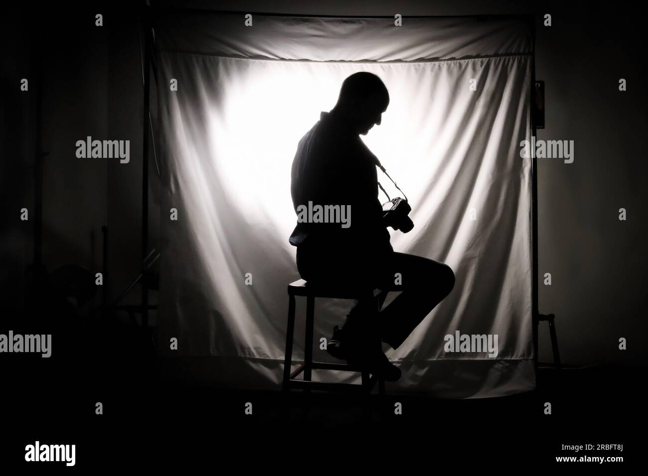 In the photography studio - Silhouette of photographer with camera ...