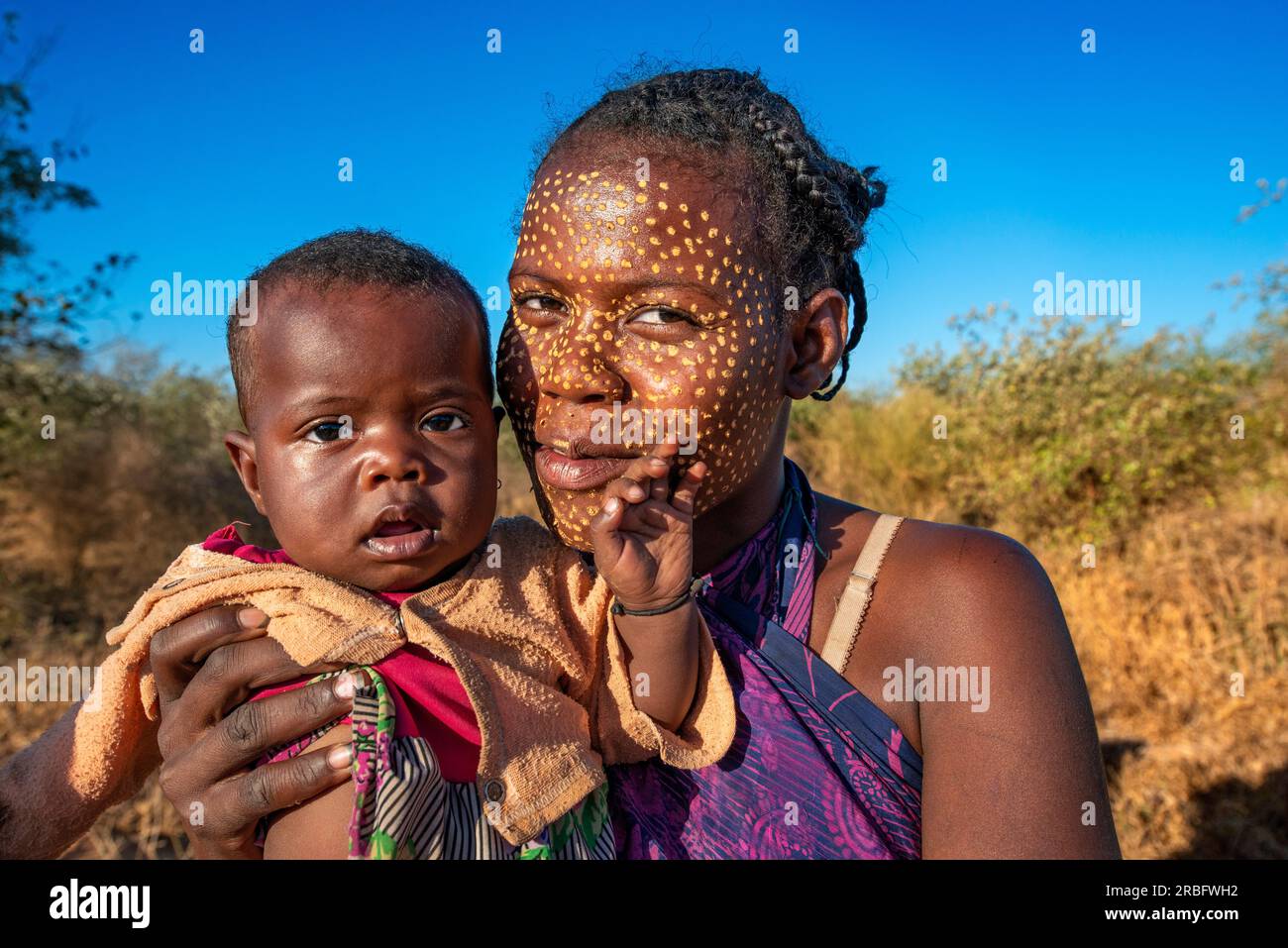Malagasy morondava woman with her child in the baobab avenue of ethnic ...