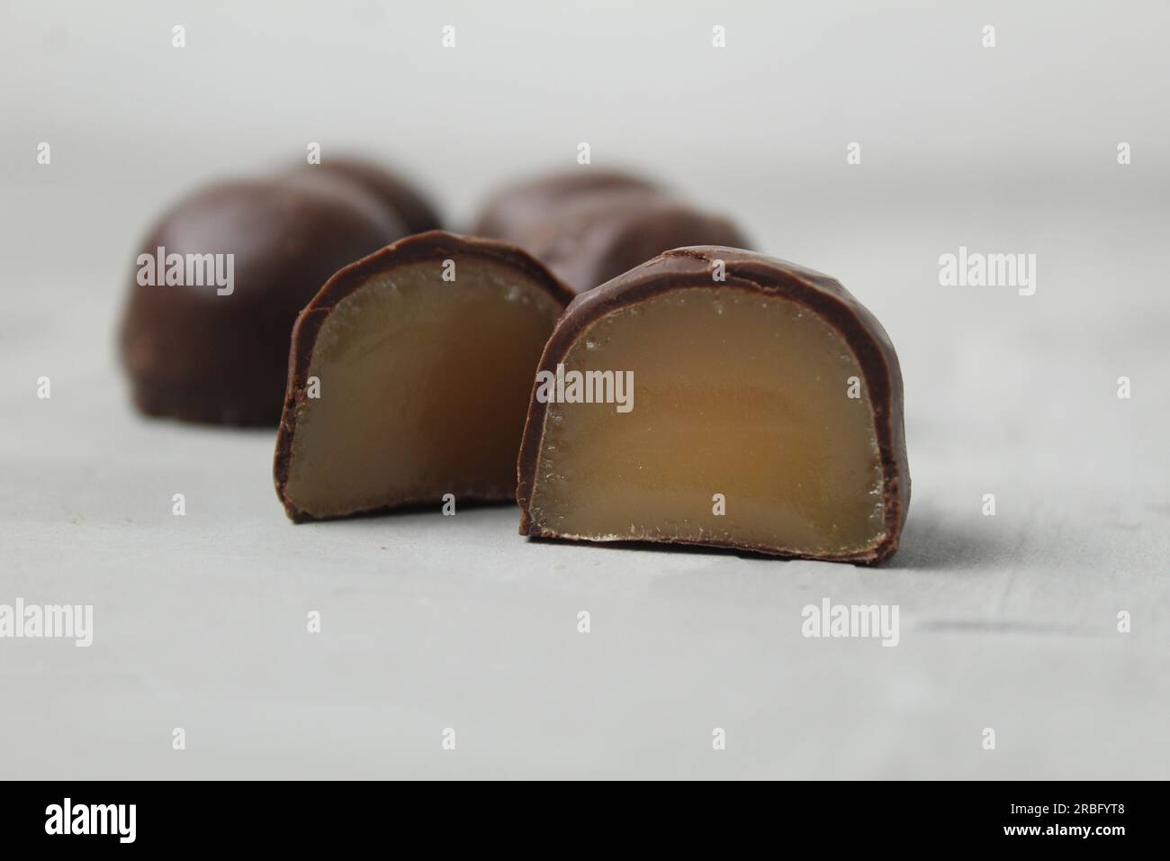 Chocolate body candy in a cut with a creamy praline filling on a white ...