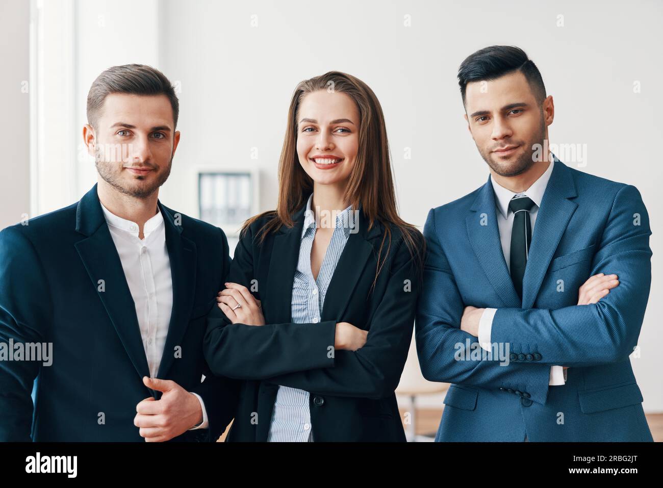 Group of successful smiling business people with with crossed arms in office. Confidence concept ...