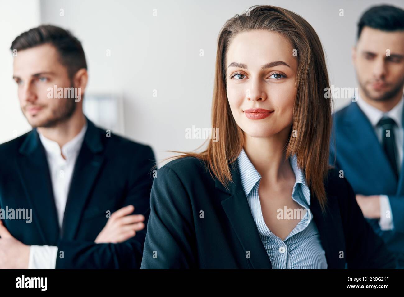 Group of successful business team with crossed arms and their pretty ...