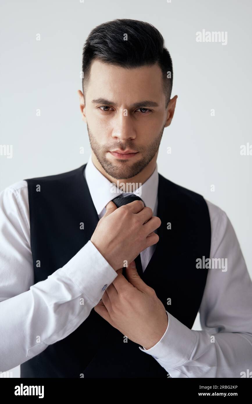 Businessman adjust necktie suit hi-res stock photography and images - Alamy