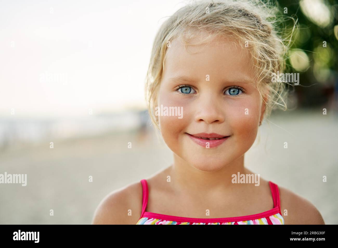 Close up portrait of happy cute little girl. Smiling blonde child on ...
