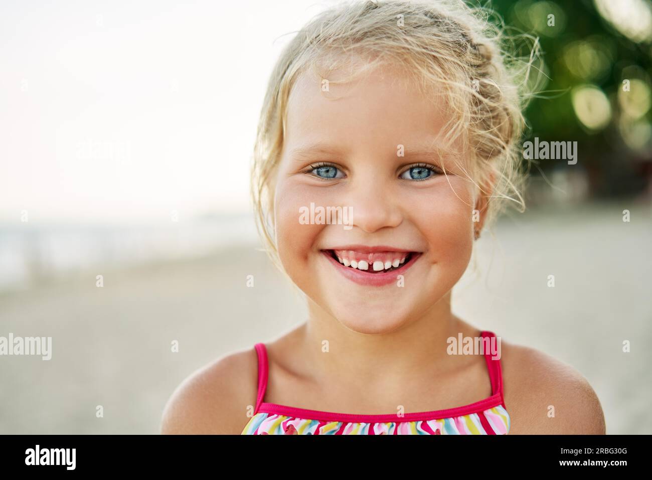 Close up portrait of happy cute little girl. Smiling blonde child on ...
