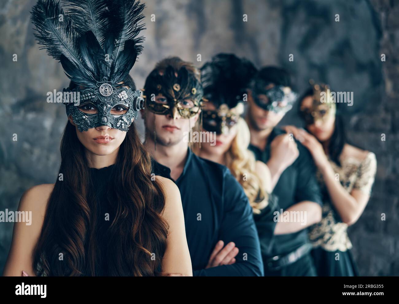 Group of people in masquerade carnival mask posing in studio. Beautiful ...