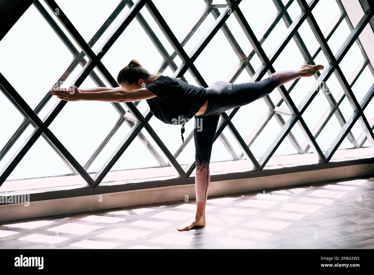 Young attractive woman practicing yoga doing Warrior 3 Pose large ...