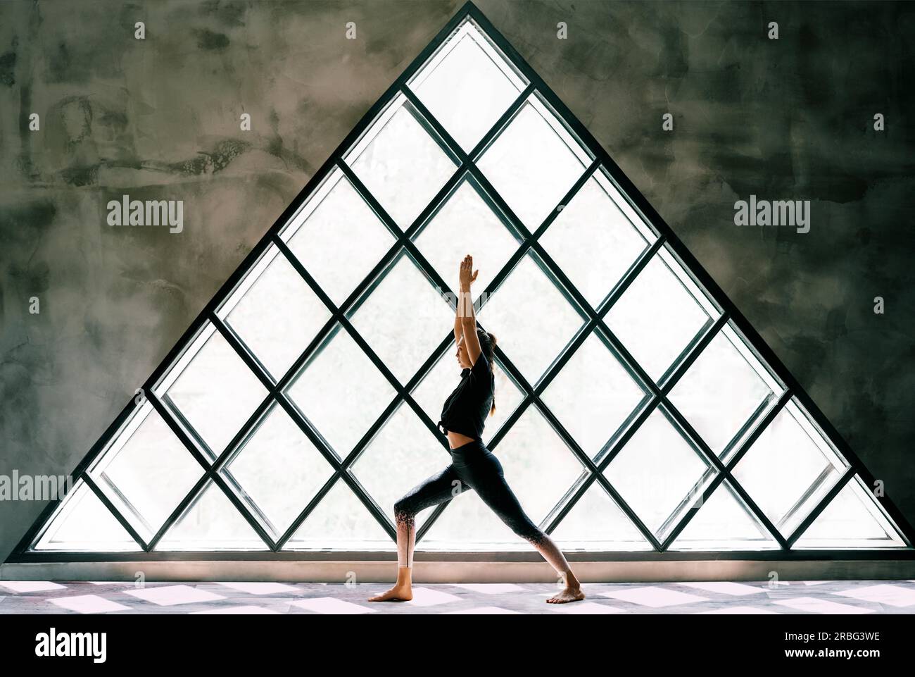 Young beautiful woman doing yoga asana Warrior I Pose on large ...