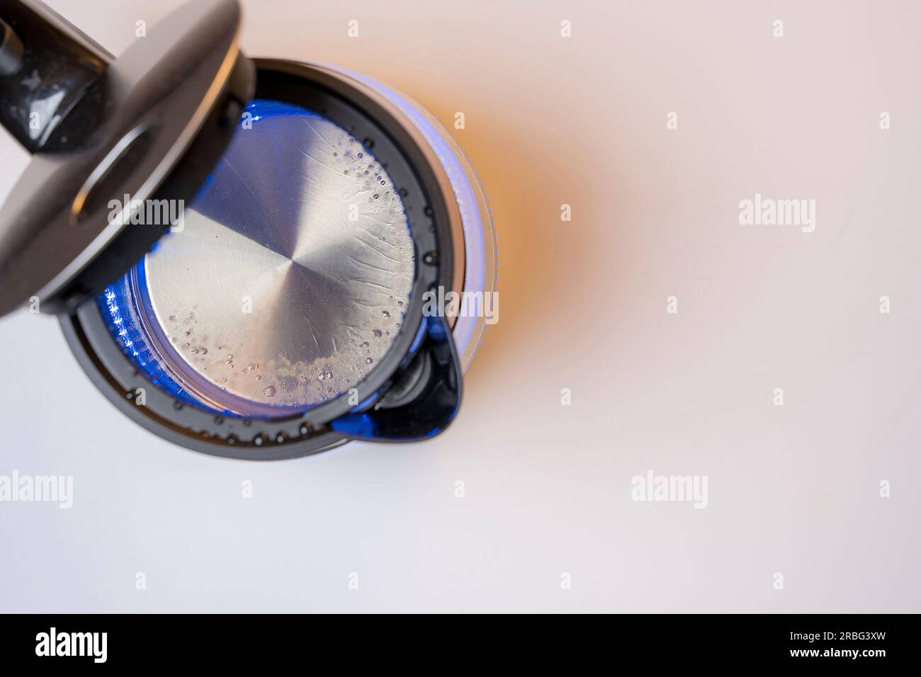 a new red modern boiling glass electric kettle with an open lid close ...