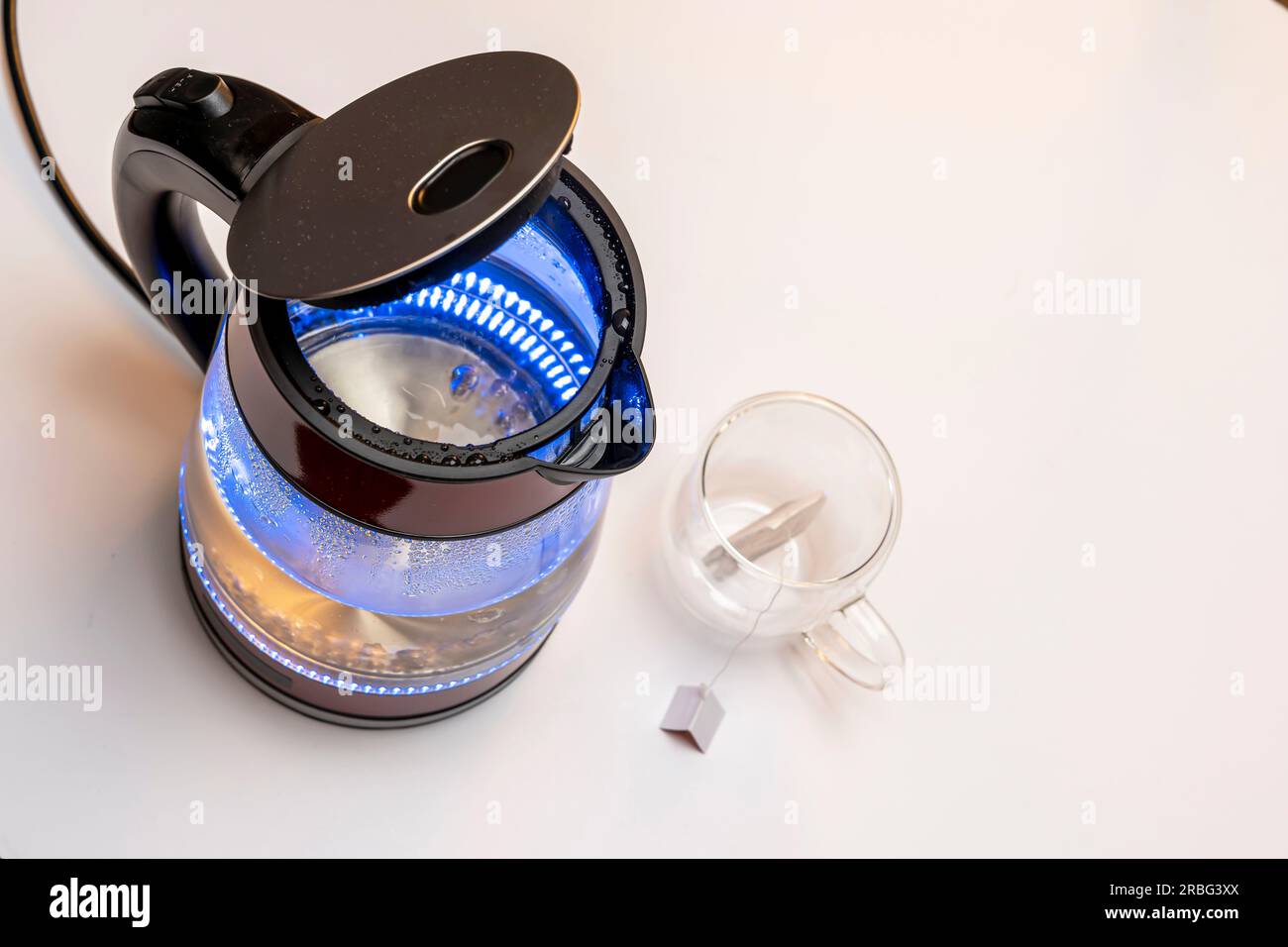 a new red modern boiling glass electric kettle with an open lid close ...