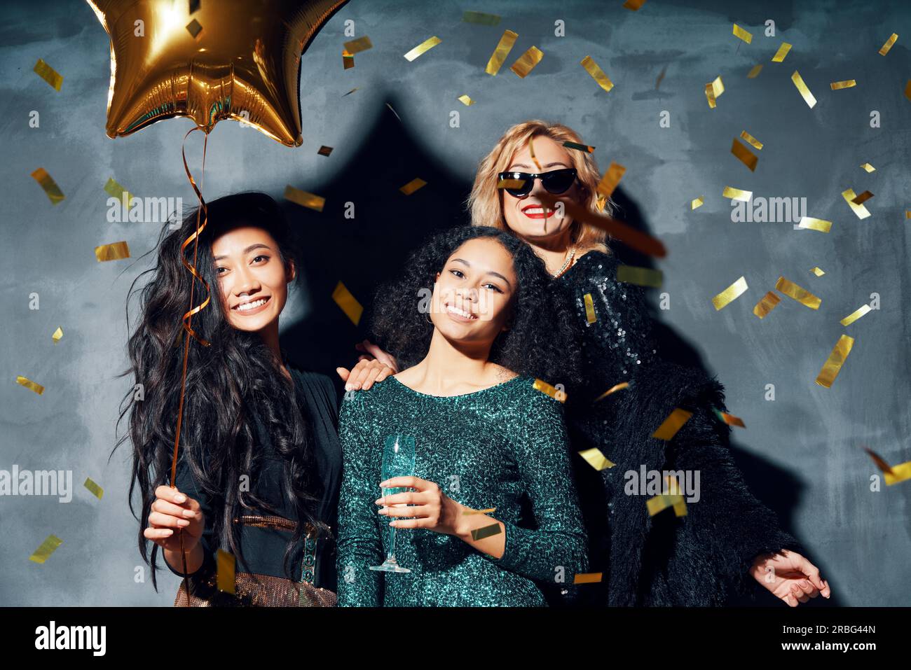 Pretty multiethnic young women have fun together celebrating with ...