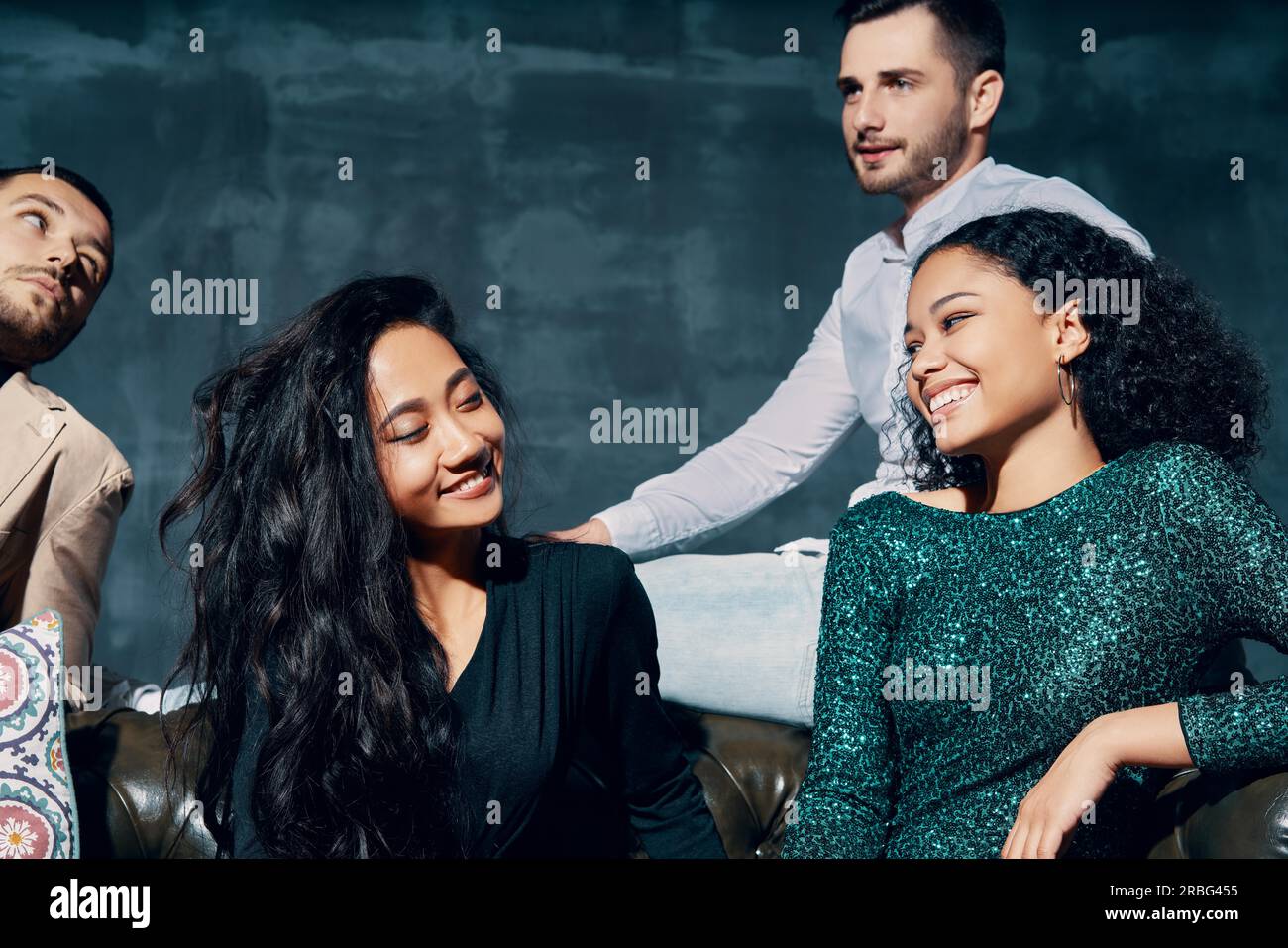 Diverse group of people enjoy party and have fun. Young friends talking ...